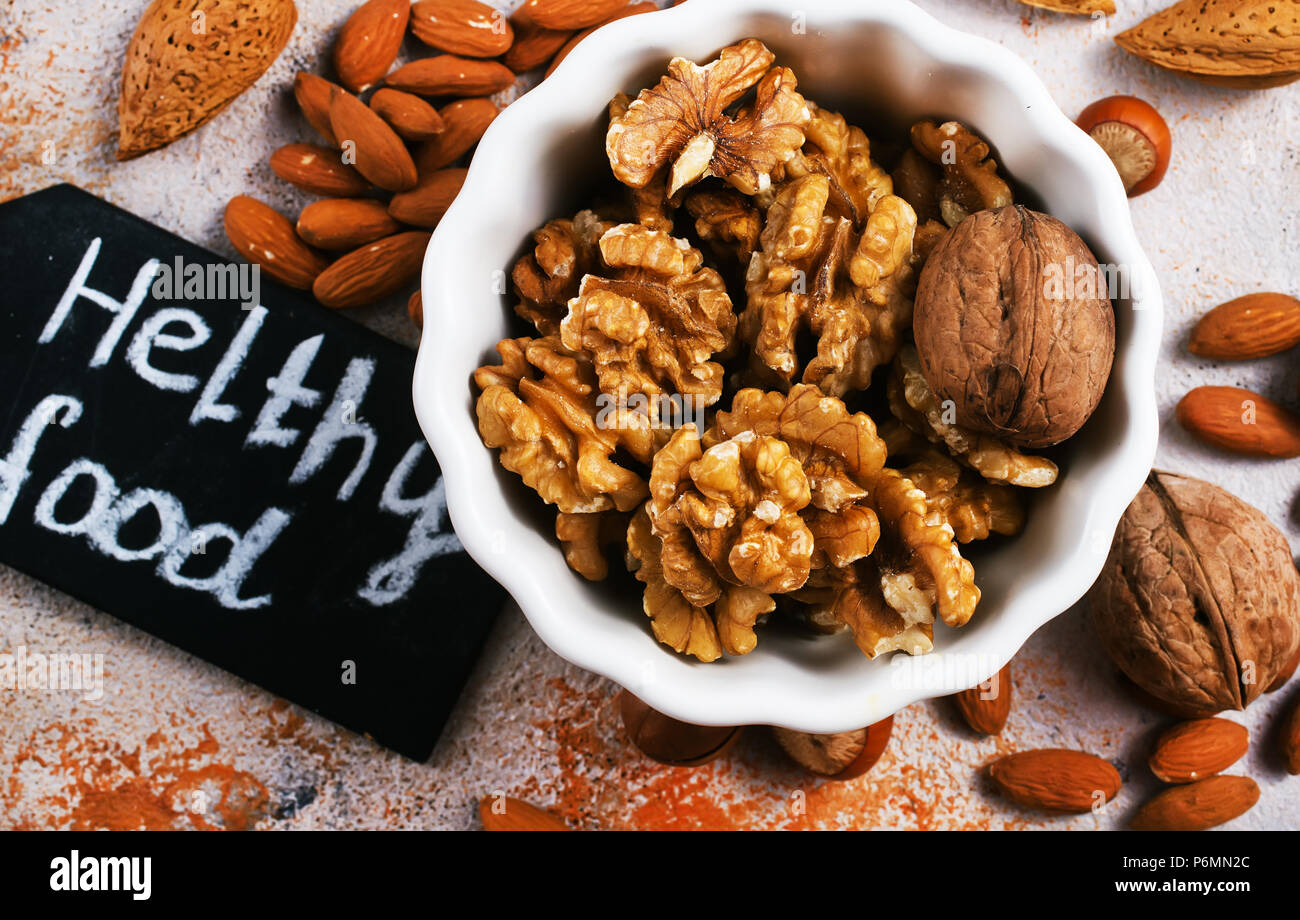 Mix nuts on beton background. Cut nuts Stock Photo - Alamy