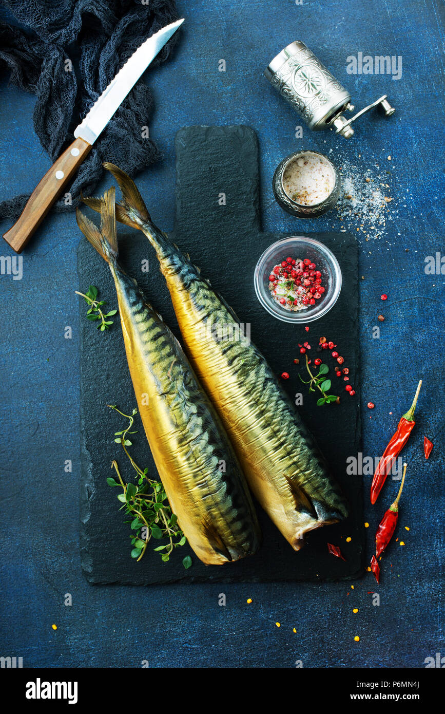 smoked fish, fish with red pepper, fish on the board Stock Photo - Alamy