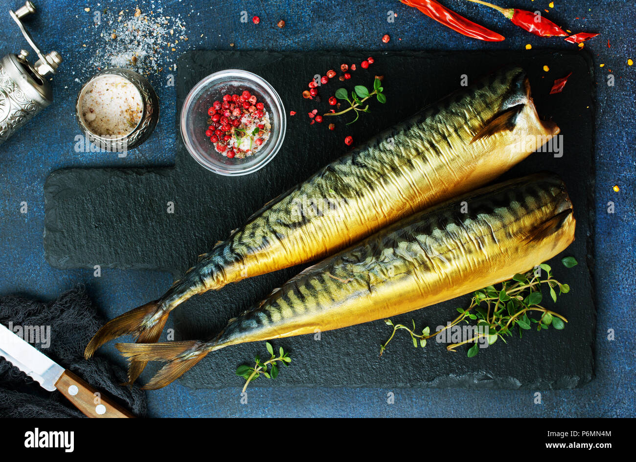 smoked fish, fish with red pepper, fish on the board Stock Photo - Alamy