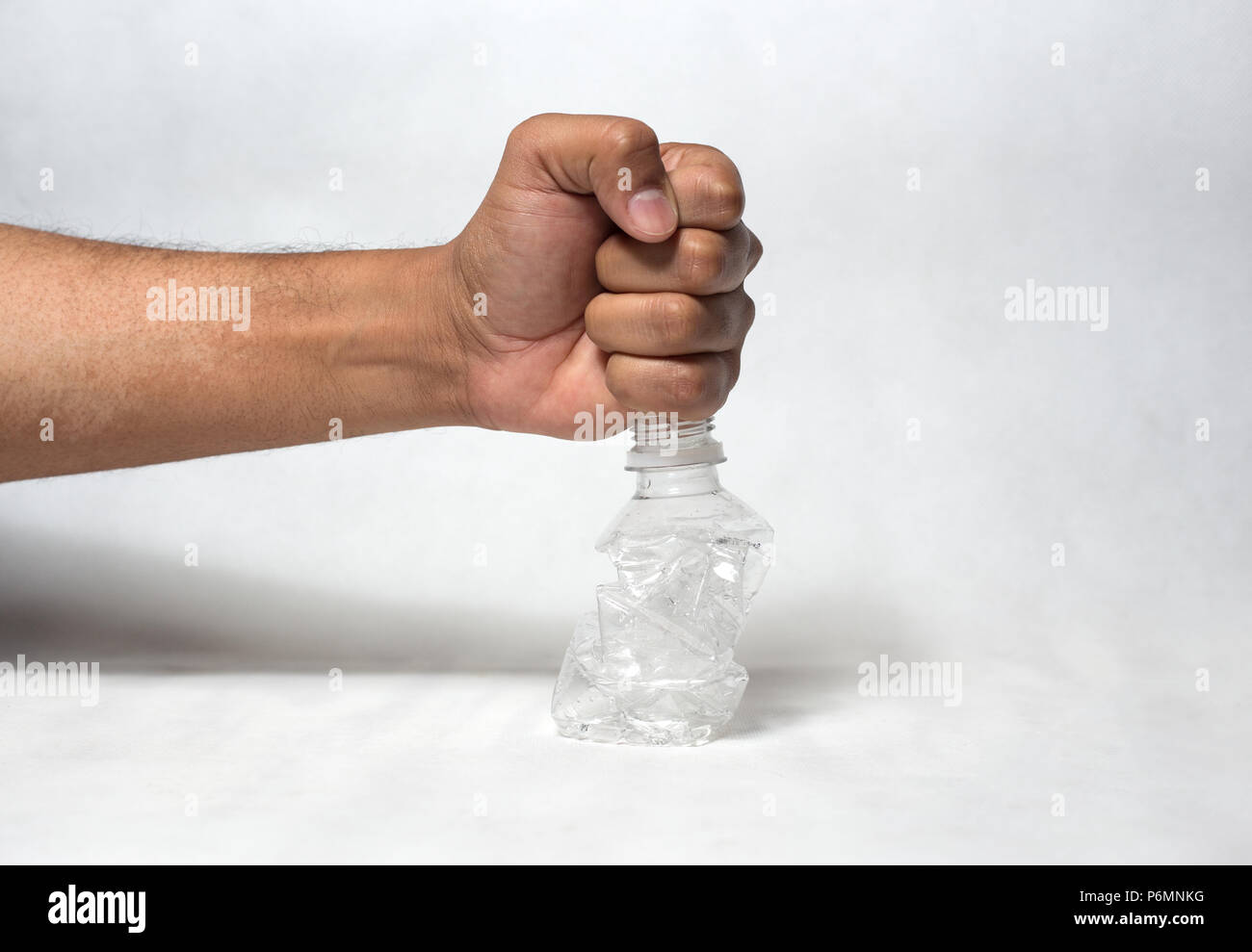 Hand Crushing plastic water bottle against single use plastic Stock ...