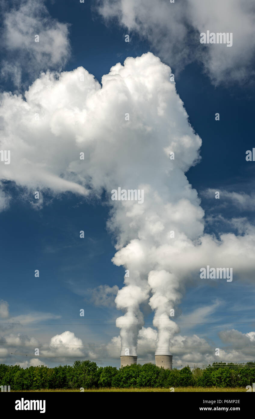 Nuclear reactor cloud making cooling towers above a grove of trees ...