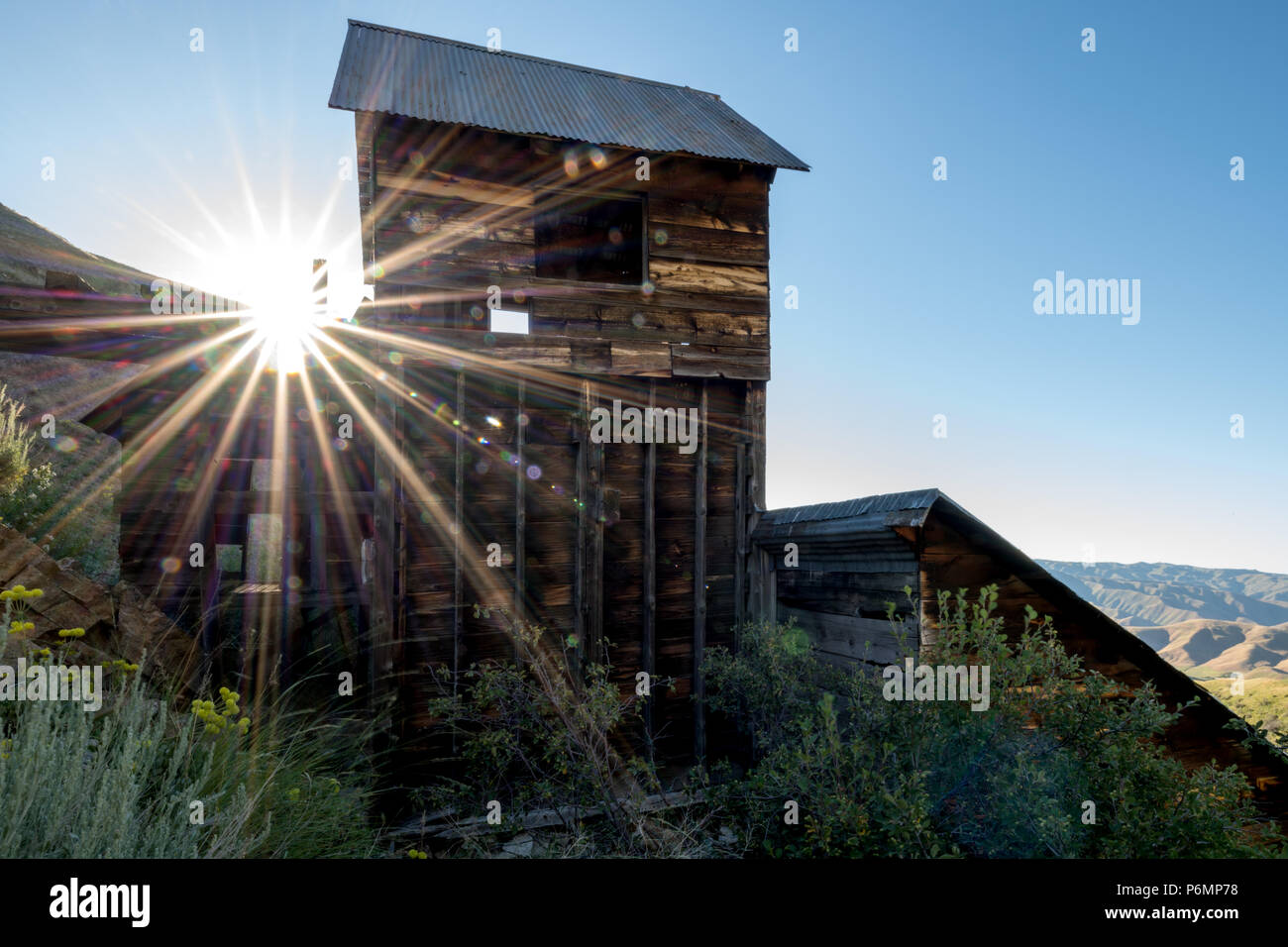 Old wooden abandoned mining shack with the morning sun shining through ...