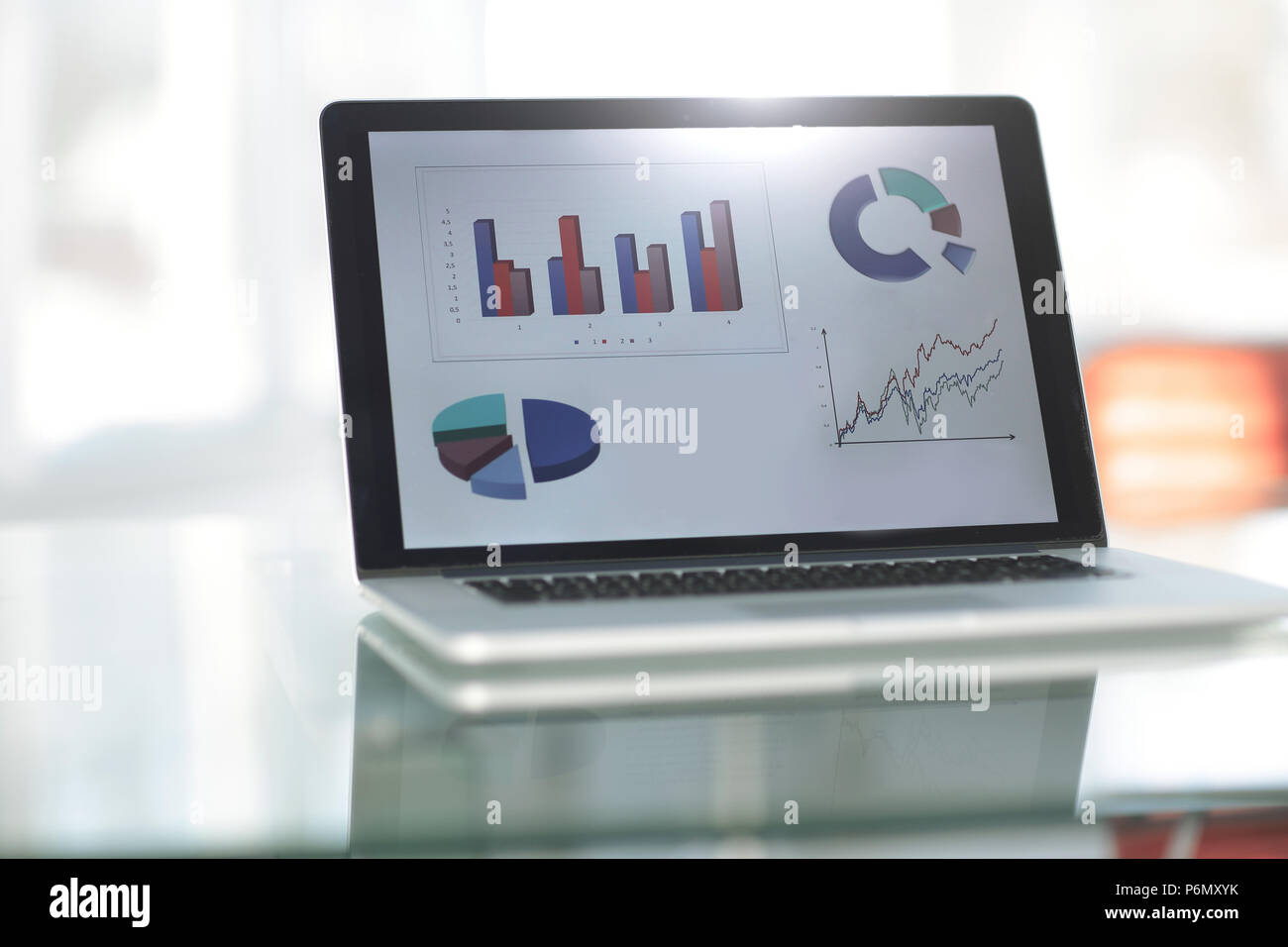 Closeup of laptop with graphs on screen on white modern office desk ...