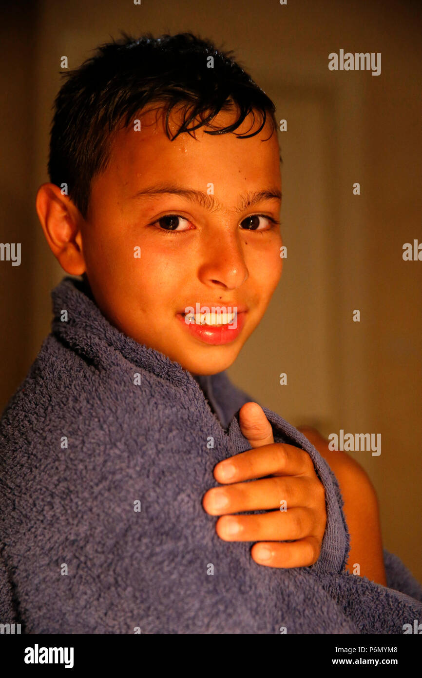 11-year-old boy coming out of a bathroom in Salento, Italy Stock Photo ...