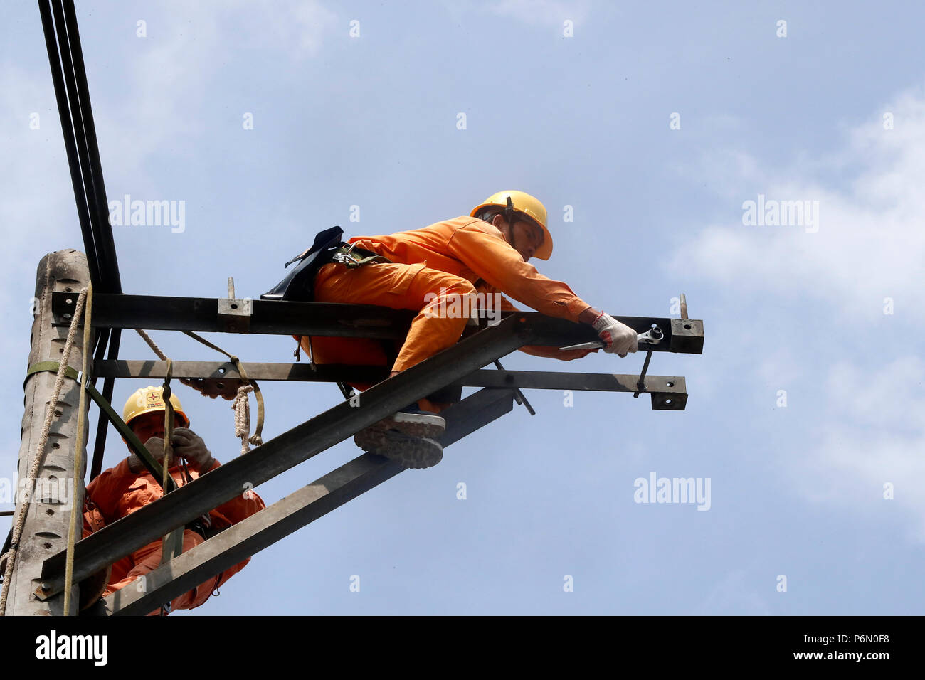 Maintenance electrician repairing electricity pylon. Cai Be. Vietnam ...