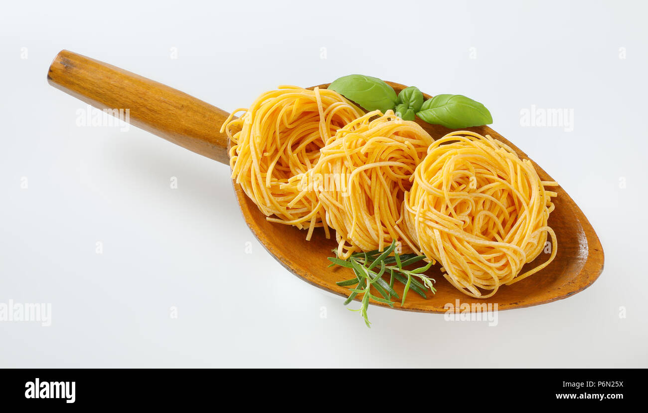 bundles of spaghetti pasta and herbs in wooden scoop Stock Photo - Alamy