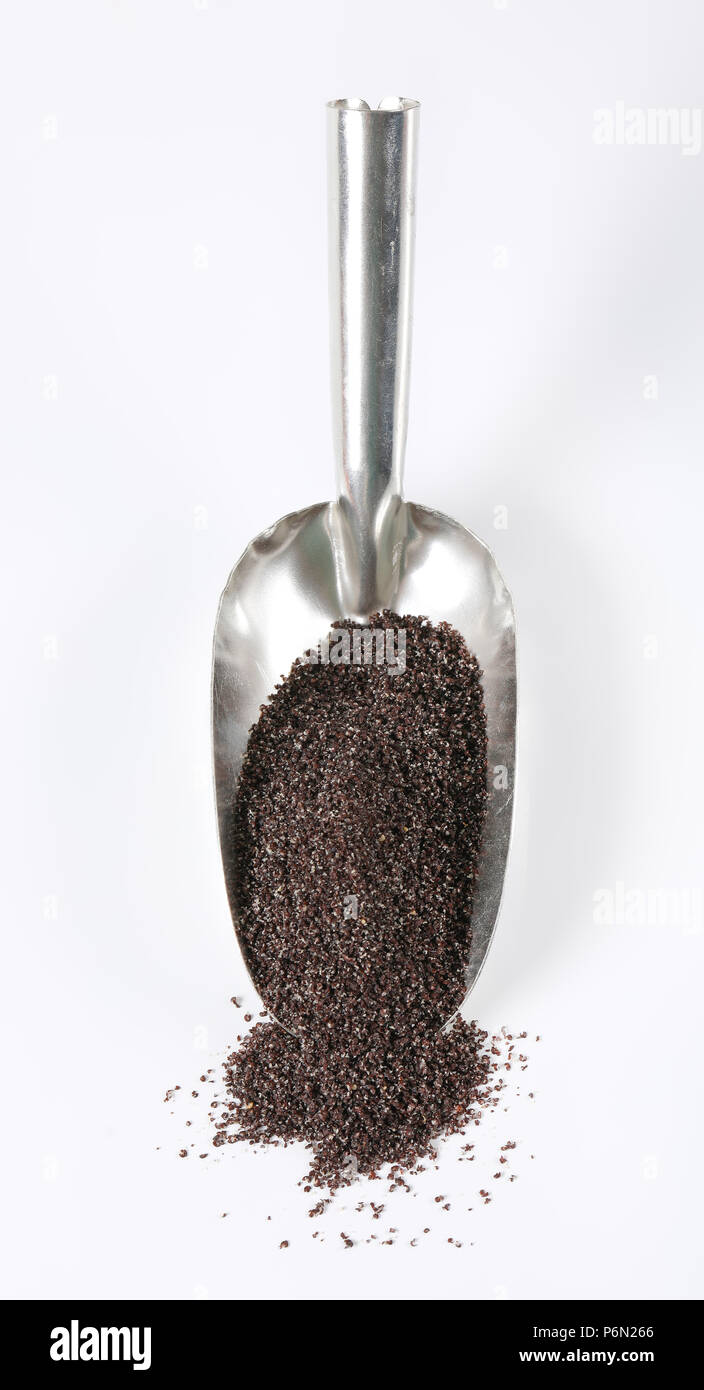 scoop of ground poppy seeds on white background Stock Photo - Alamy