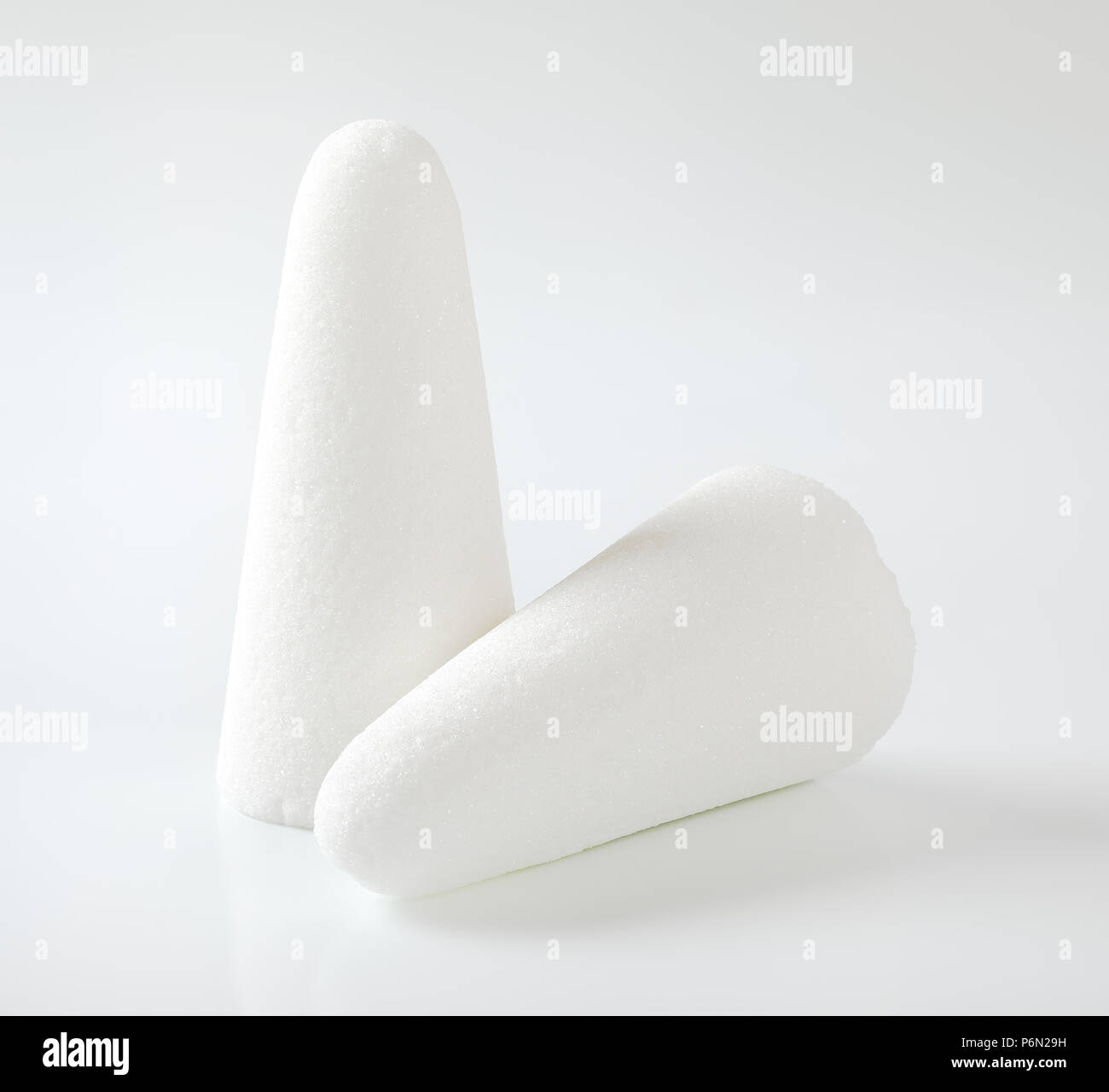 two white sugar loaves or cones on white background Stock Photo - Alamy