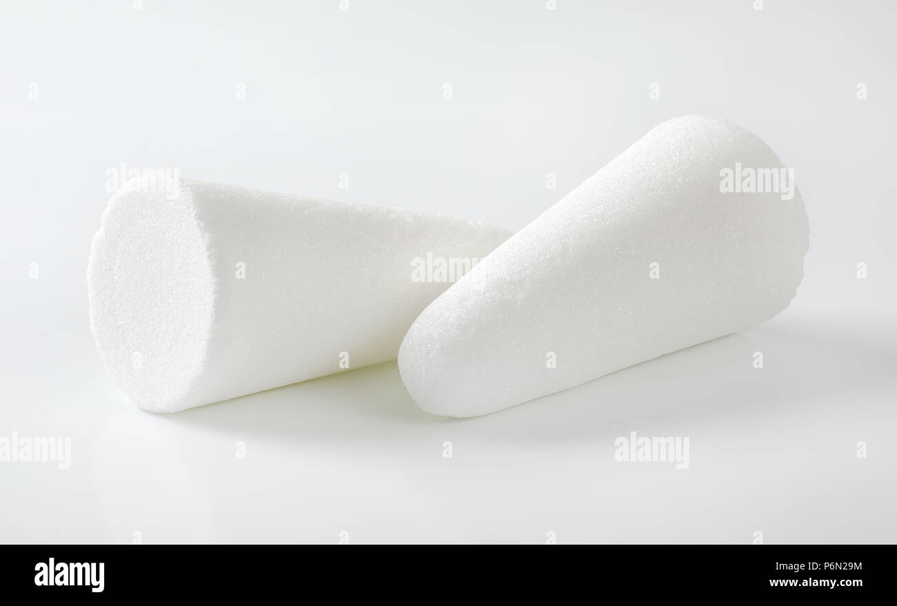 two white sugar loaves or cones on white background Stock Photo - Alamy
