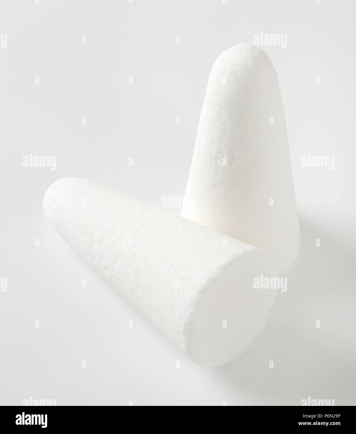 two white sugar loaves or cones on white background Stock Photo - Alamy