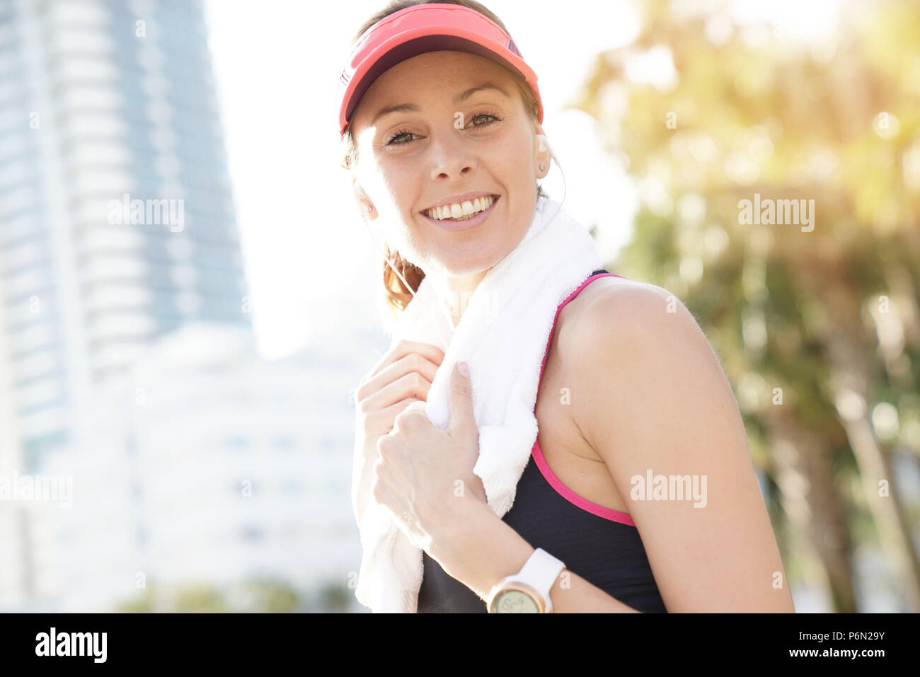 Portrait of smiling jogger woman Stock Photo - Alamy