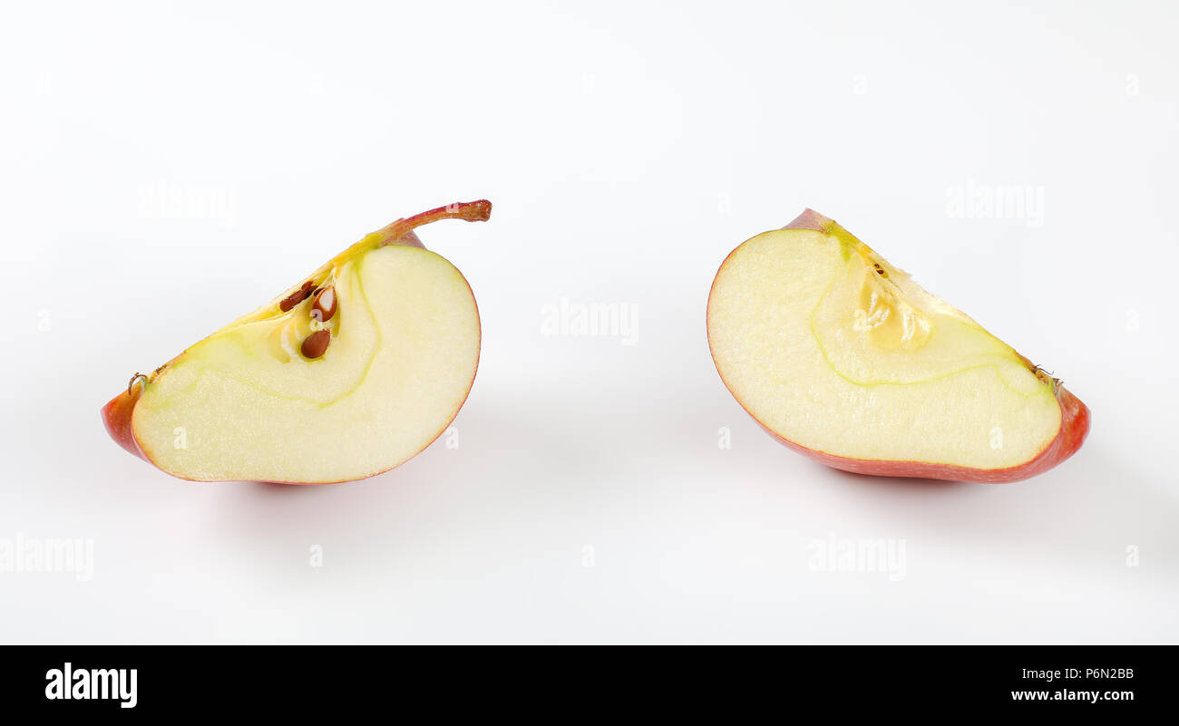red apple wedges on white background Stock Photo - Alamy