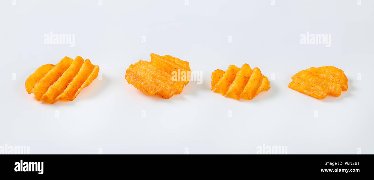 four fried potato chips on white background Stock Photo - Alamy