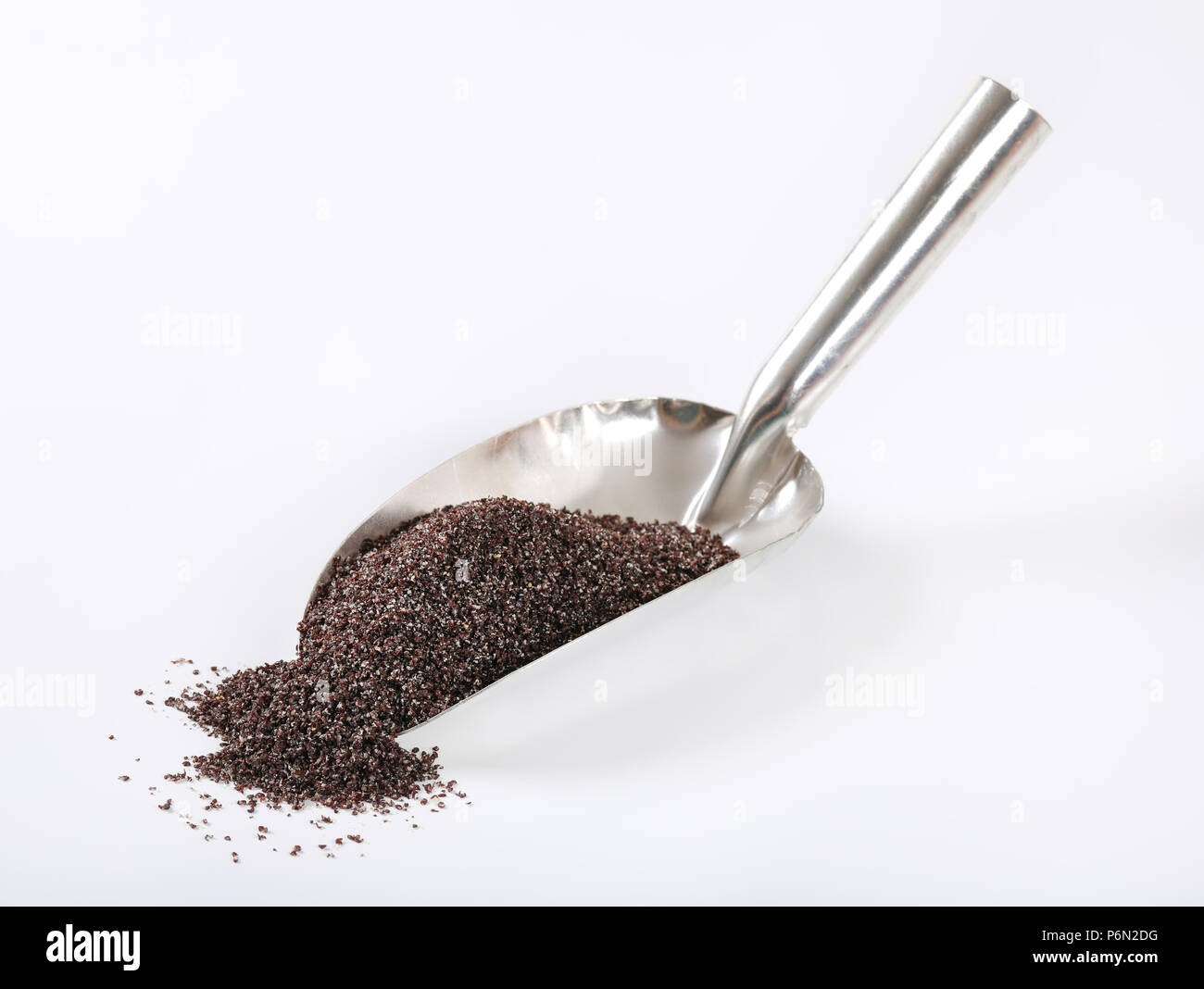 scoop of ground poppy seeds on white background Stock Photo - Alamy