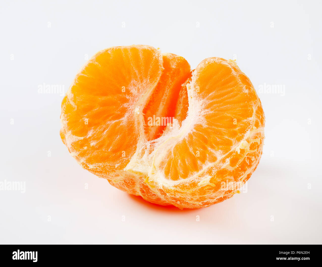half of peeled tangerine on white background Stock Photo - Alamy
