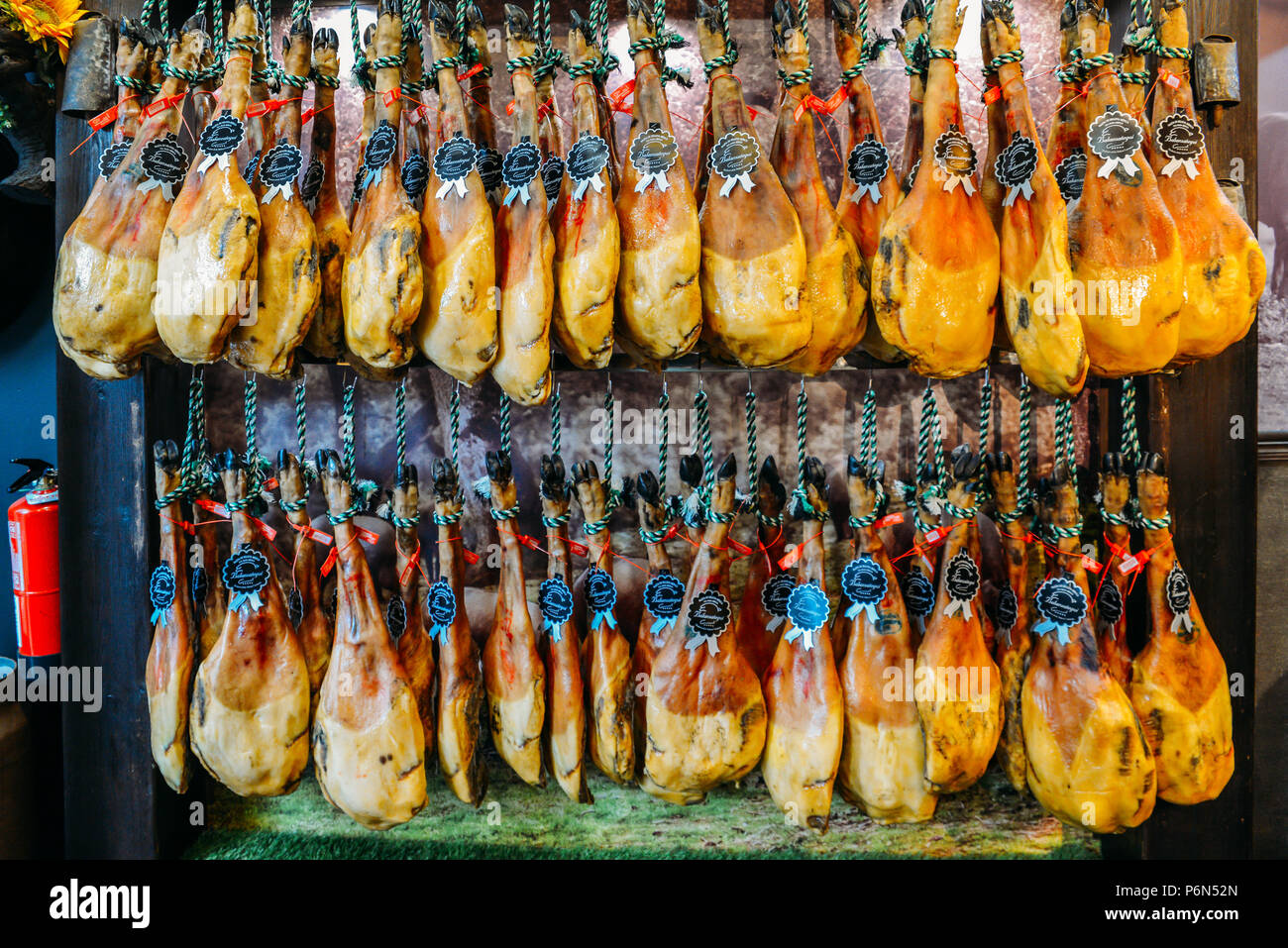 Display of the traditional spanish ham in butchers shop Stock Photo - Alamy