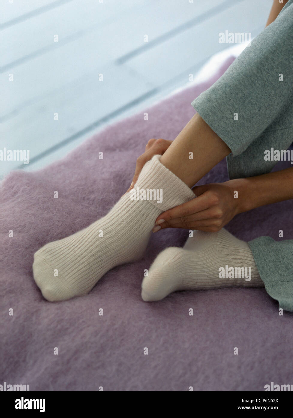 Close-up of hands pulling socks onto feet FOR EDITORIAL USE ONLY Stock ...
