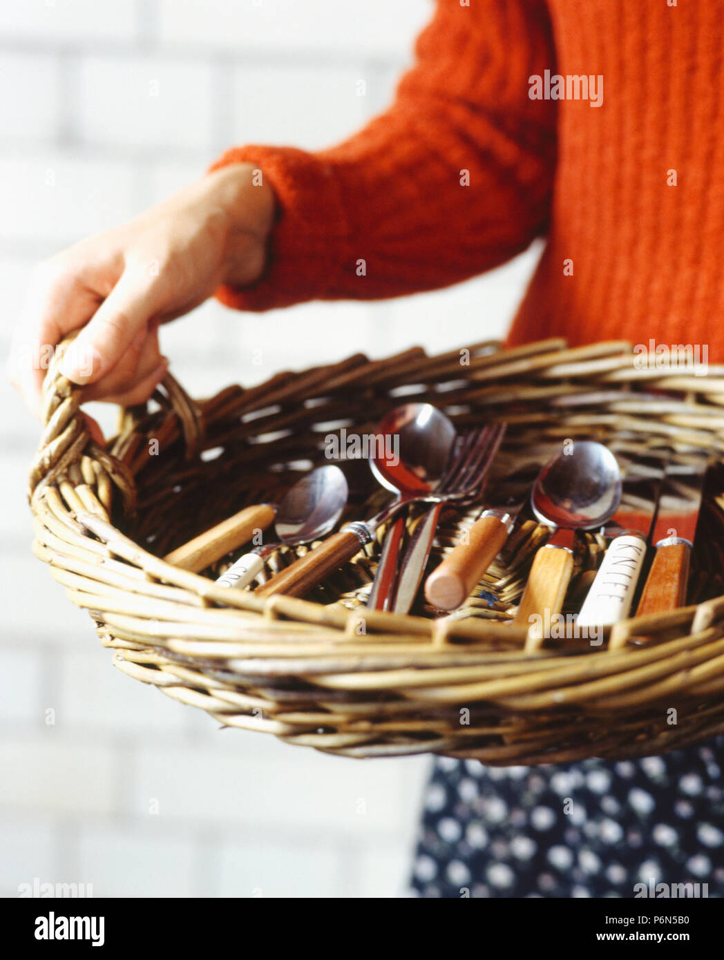 Close-up of woman carrying basket of cutlery FOR EDITORIAL USE ONLY ...