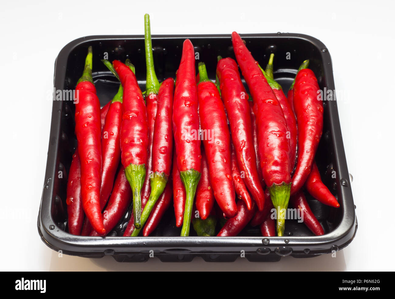 Packing of chili peppers on a white background Stock Photo - Alamy