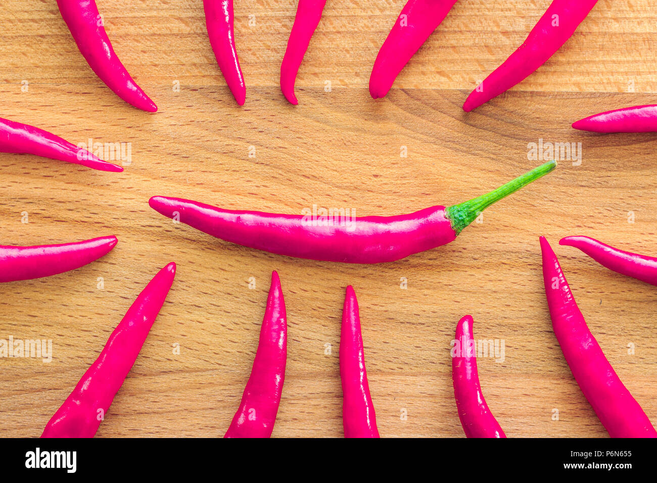 Close-up top view pink chili pepper on wood background Stock Photo - Alamy