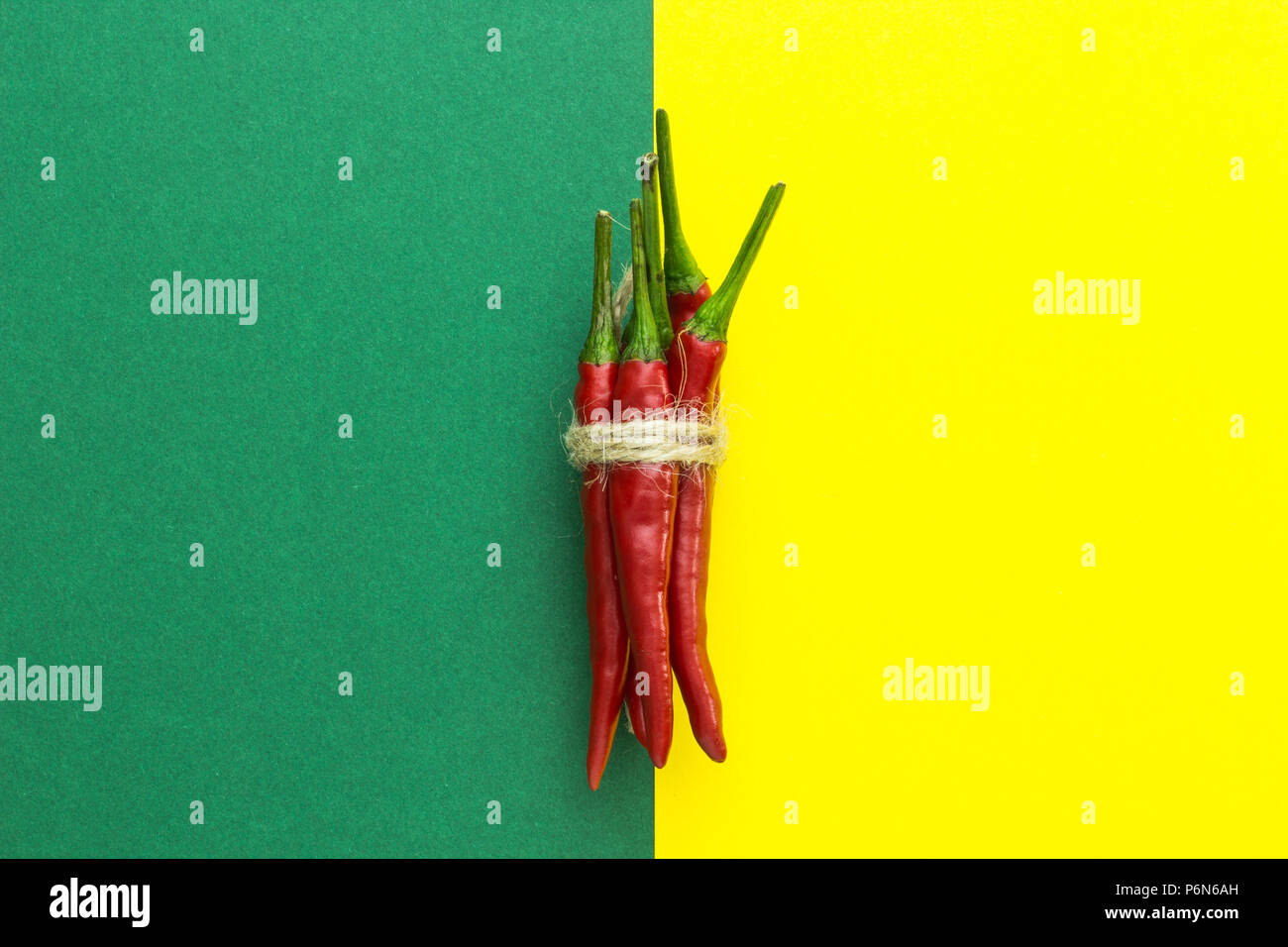 top view, red chili pepper, tied with braid on a yellow-green ...