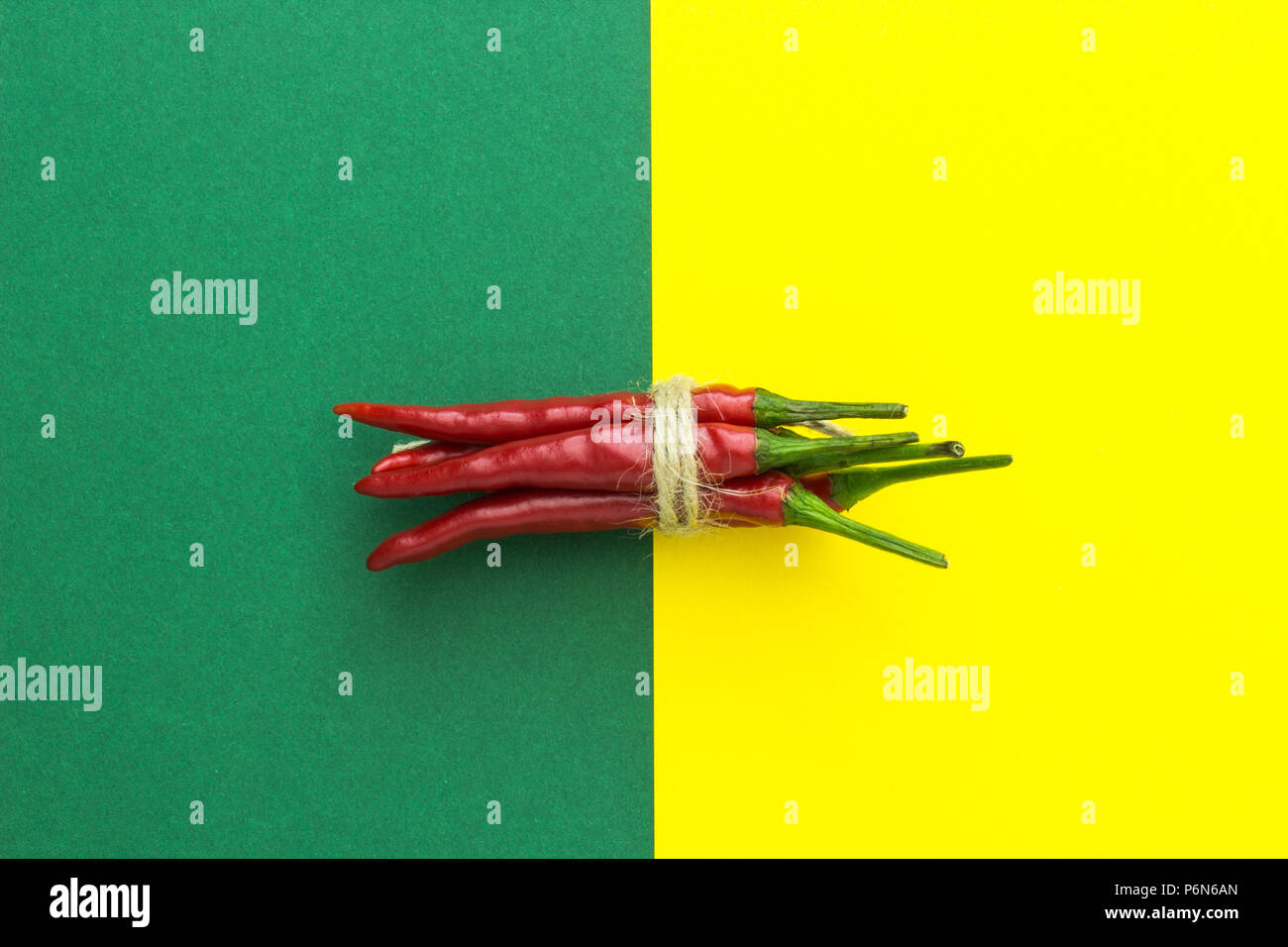 top view, red chili pepper, tied with braid on a yellow-green ...
