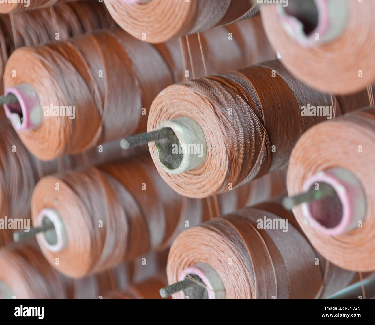 Brown yarn cone mounted in a fabrics factory Stock Photo - Alamy