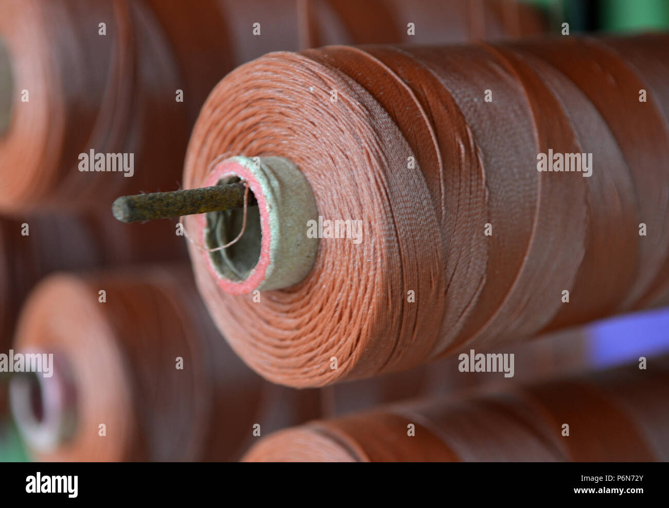 Brown yarn cone mounted in a fabrics factory Stock Photo - Alamy