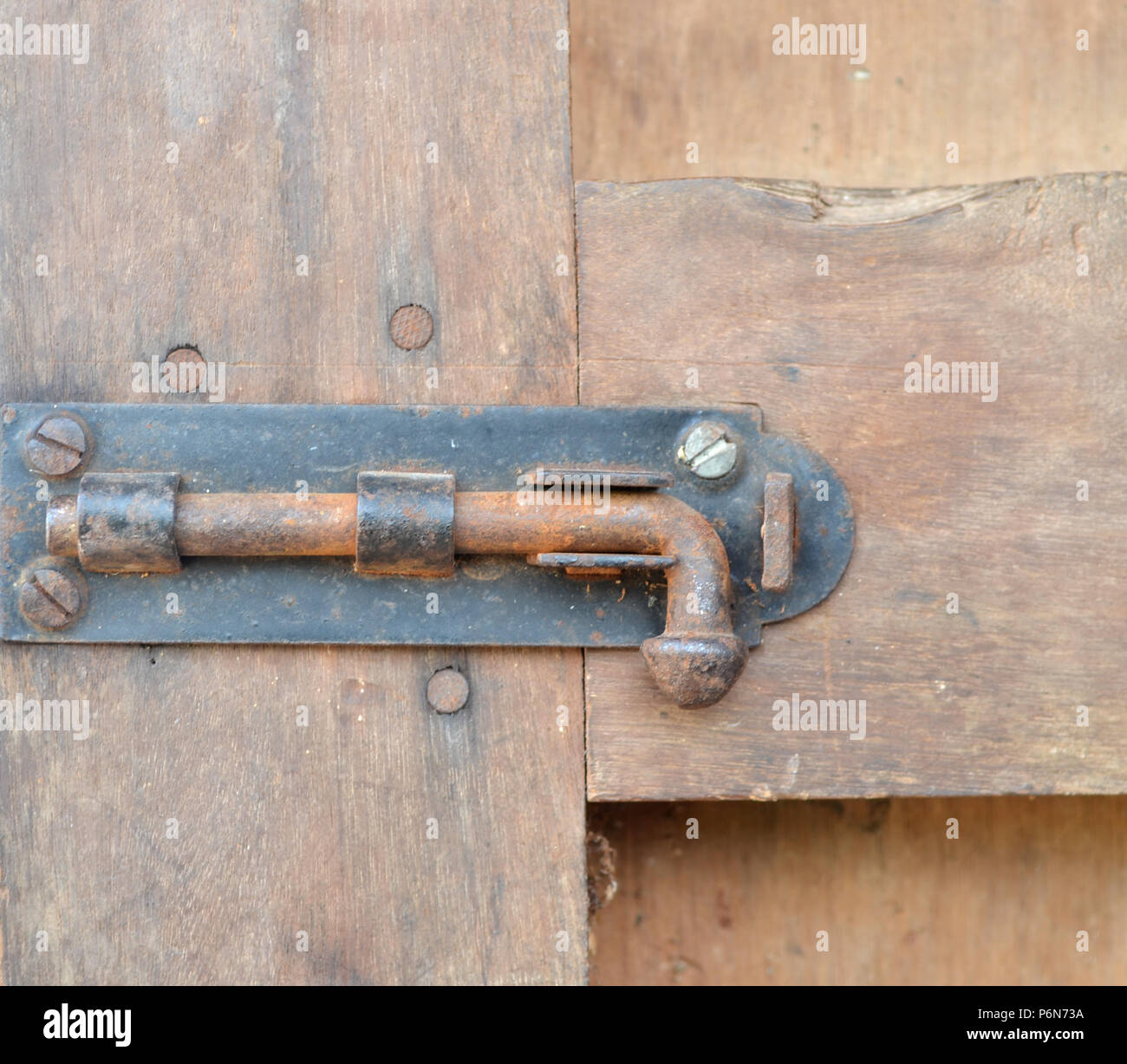Old latch with padlock on doors Stock Photo - Alamy