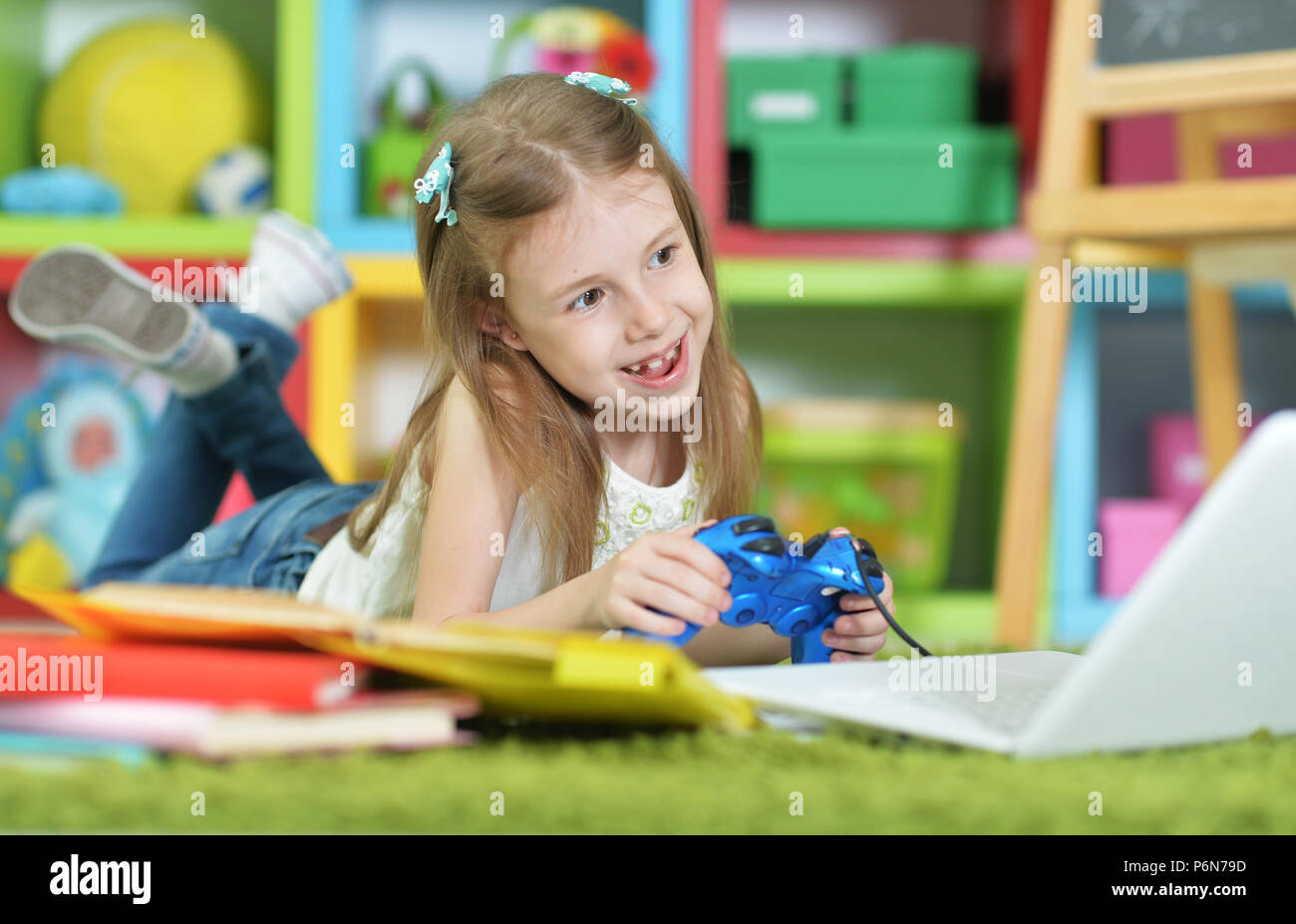 Cute girl playing computer game at home Stock Photo - Alamy