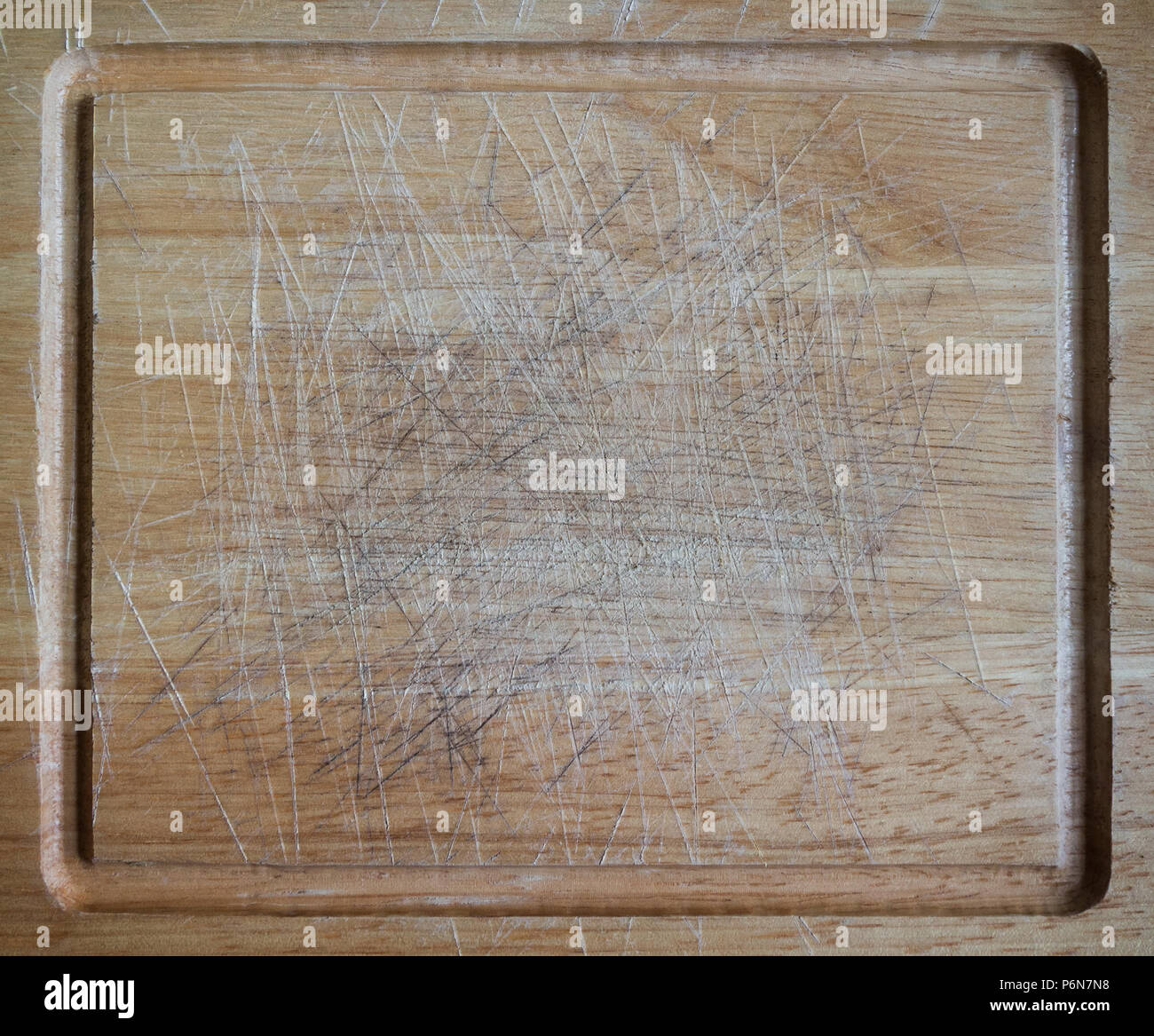 Full frame background of an old wooden chopping board with cutting ...