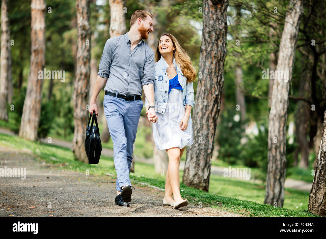 Beautiful couple taking a walk in nature Stock Photo - Alamy