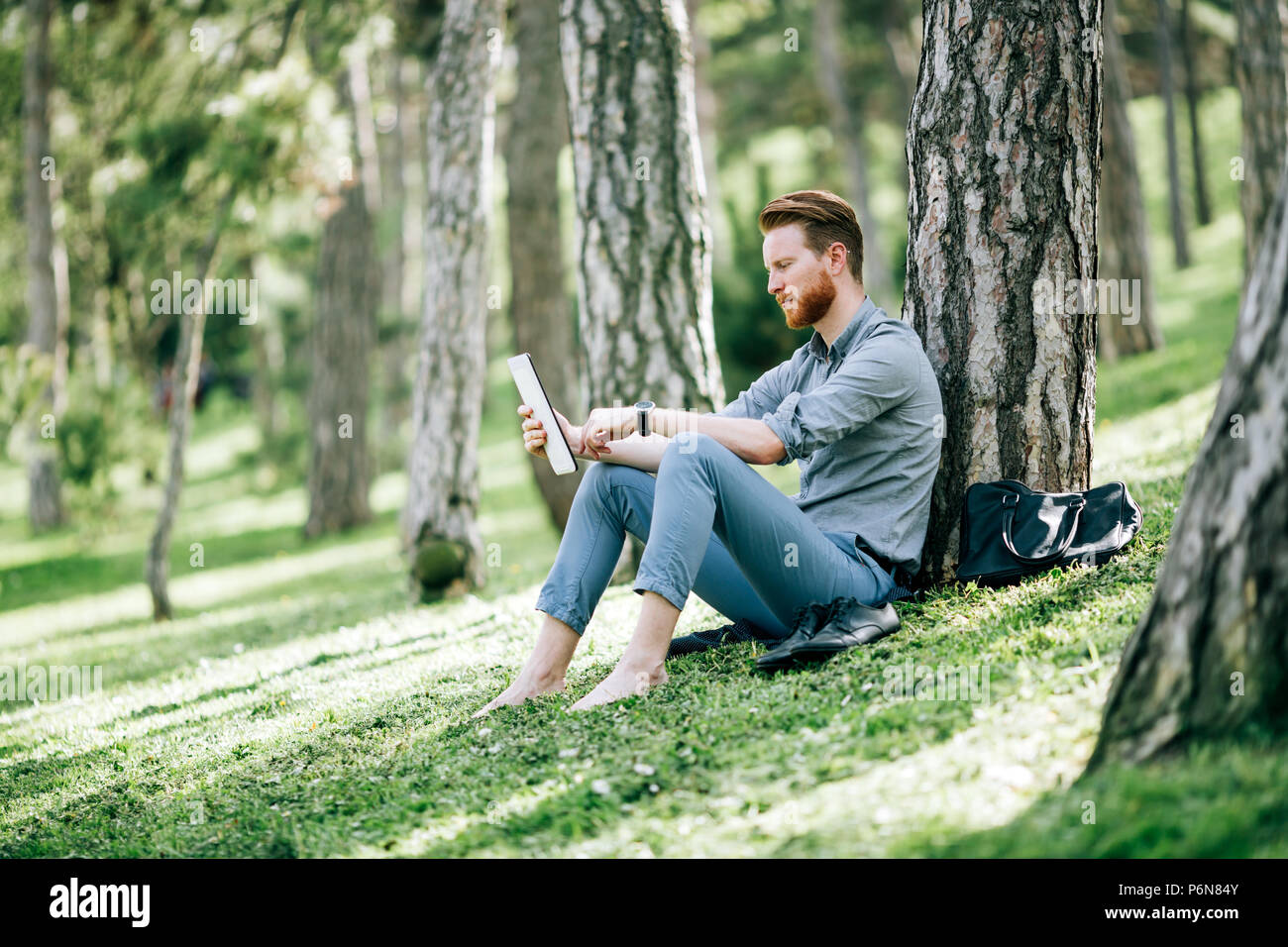 Handsome student reading in nature Stock Photo - Alamy