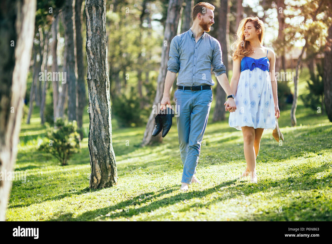 Romantic couple walking forest Stock Photo - Alamy