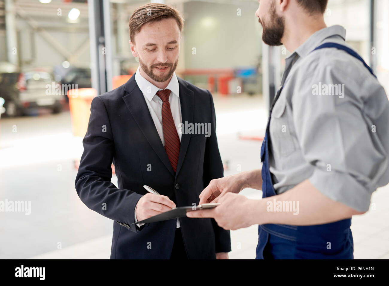 Businessman Signing Car Service Contract Stock Photo - Alamy