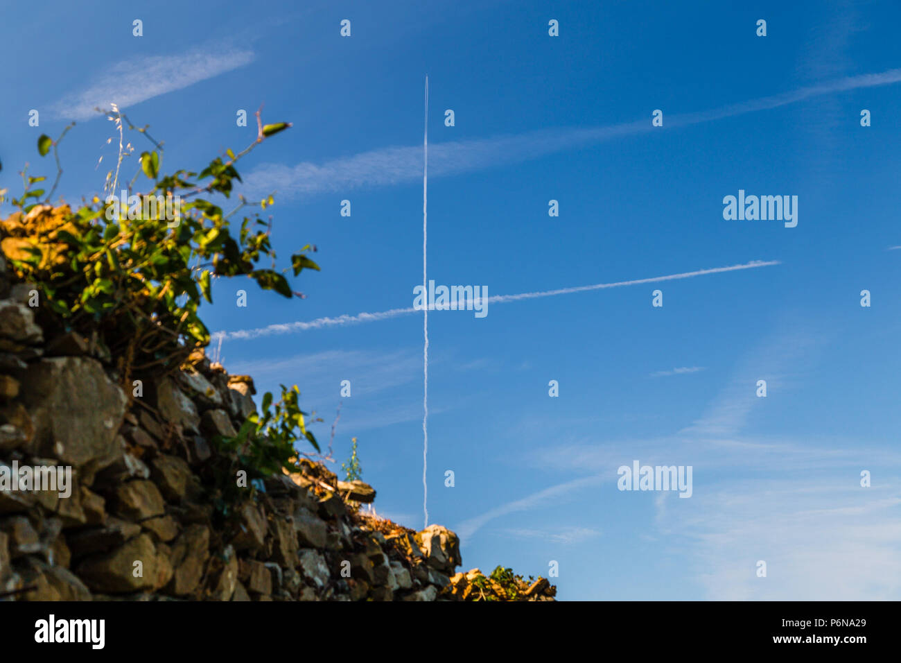 Crossed plane trails in the sky Stock Photo - Alamy