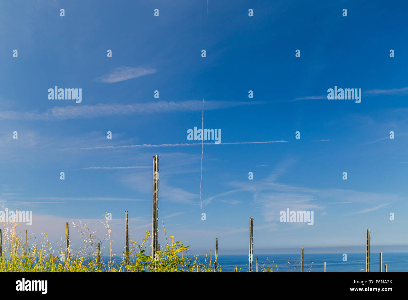 Crossed plane trails in the sky Stock Photo - Alamy