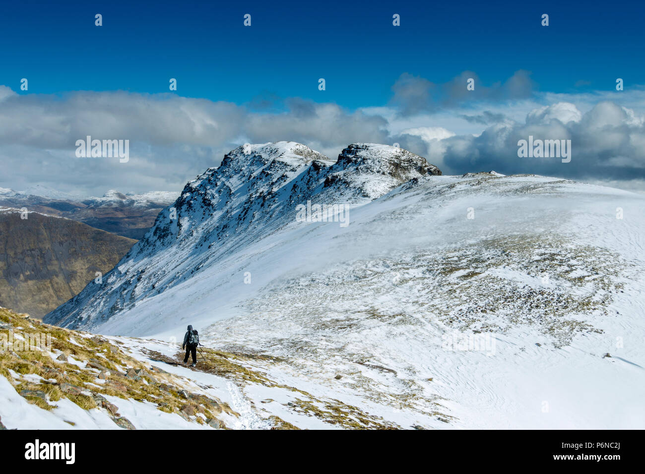 A hill walker on the ridge of Sgùrr a' Chaorachain in the Applecross ...