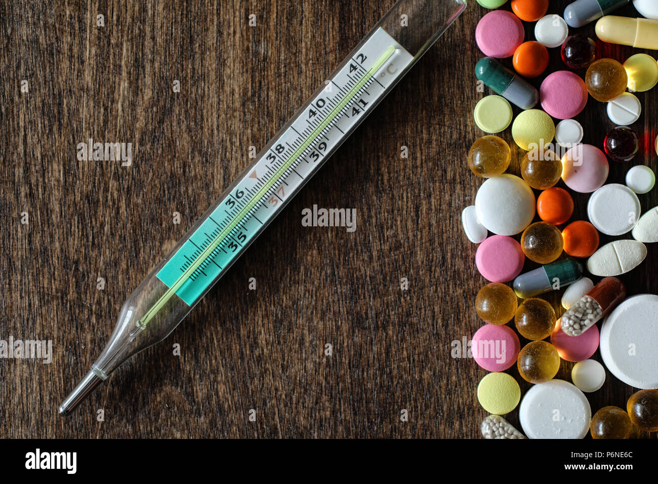 Medical background of various colorful medications on a textured wooden ...