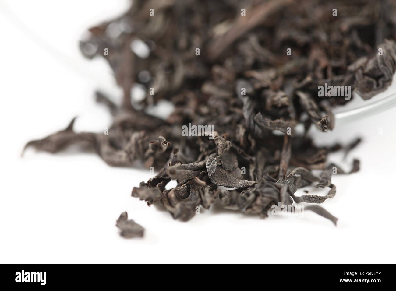 dry black tea leaves on white background. Shallow dof Stock Photo - Alamy