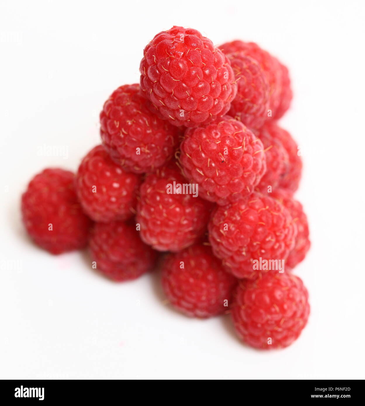 The pyramid of ripe raspberry over white background Stock Photo - Alamy