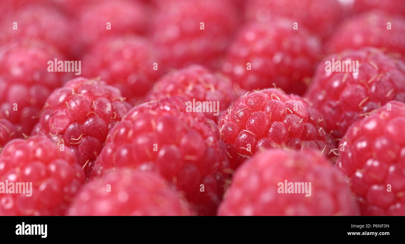 Fresh and sweet raspberries background Stock Photo - Alamy