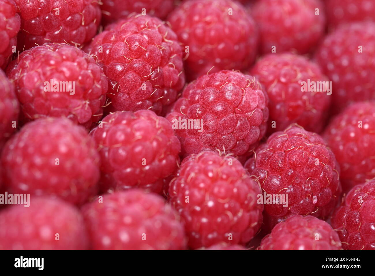 Fresh and sweet raspberries background Stock Photo - Alamy