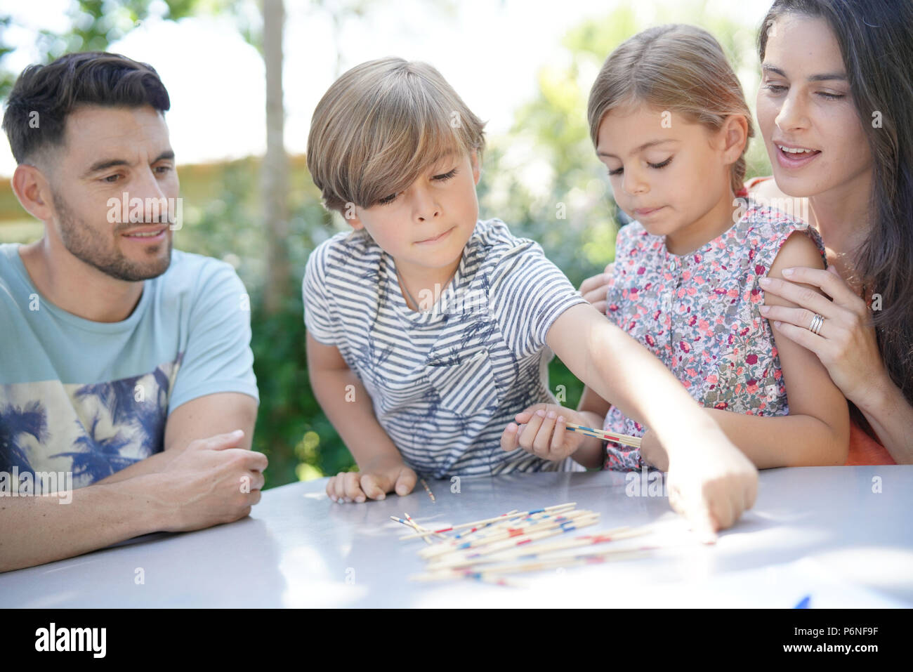 Happy family enjoying playing game together Stock Photo - Alamy