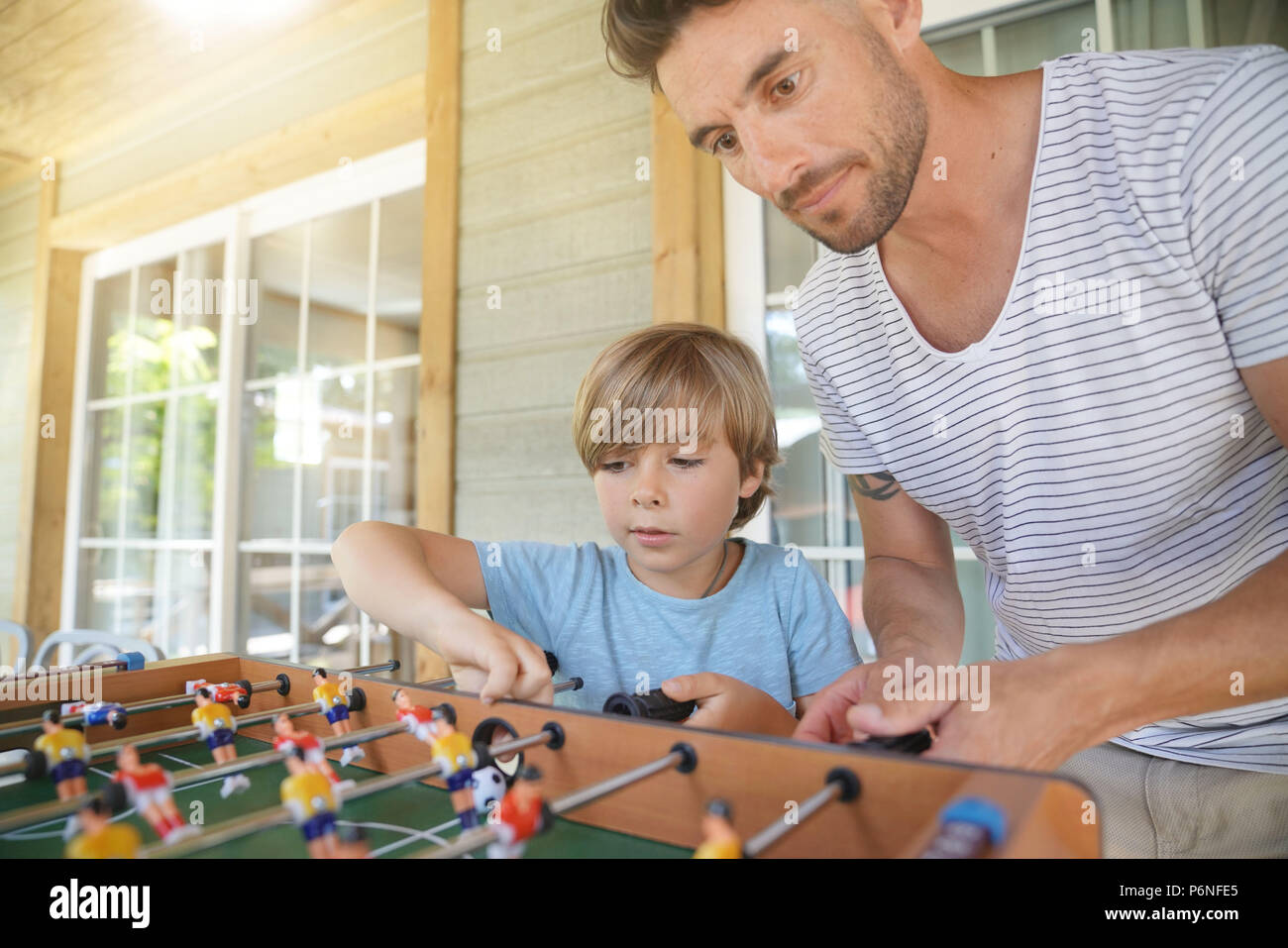 Family playing foosball Stock Photo - Alamy