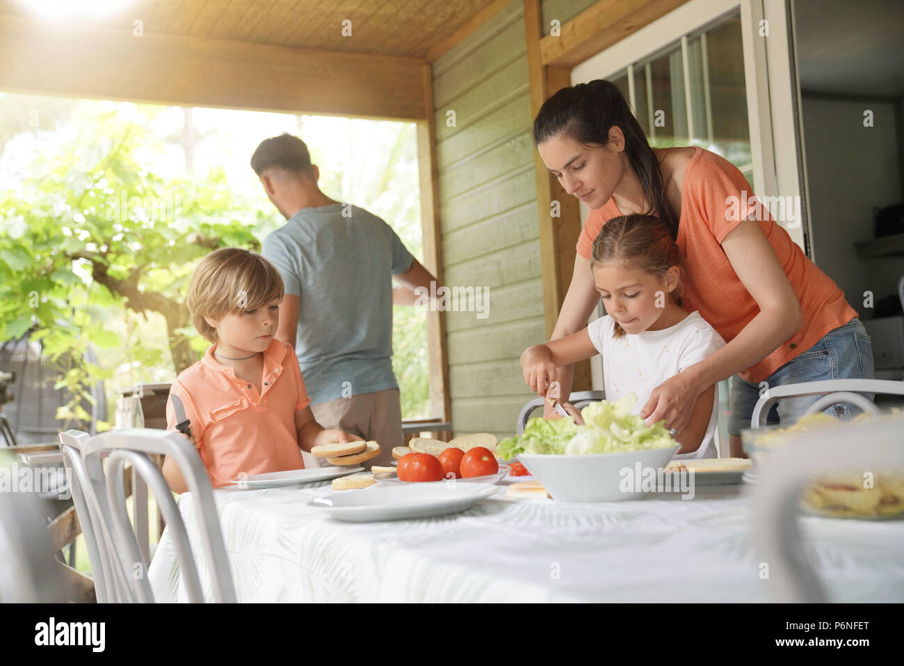 Family on vacation preparing outdoor lunch Stock Photo - Alamy