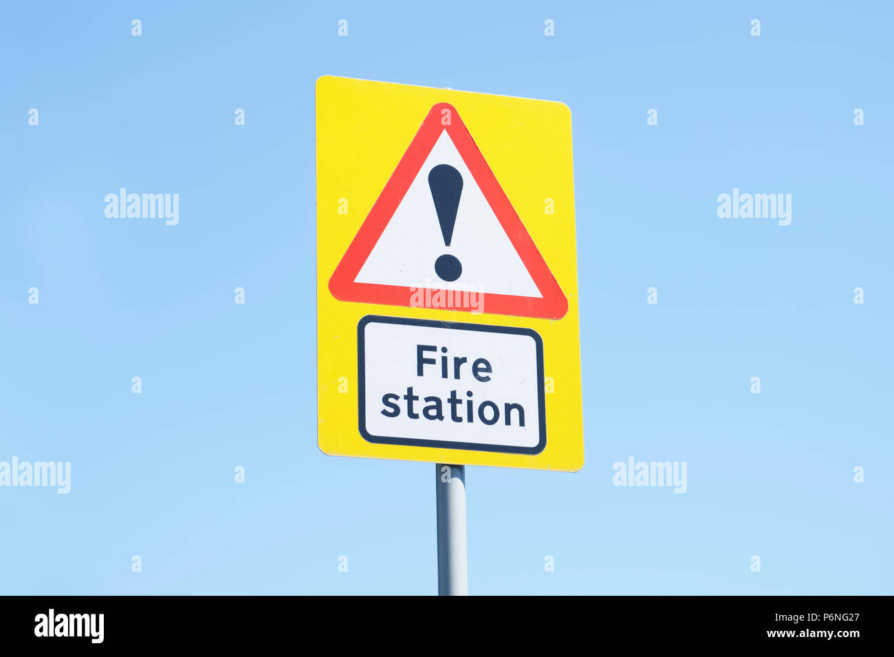 Fire station sign blue background sky yellow red white direction ...