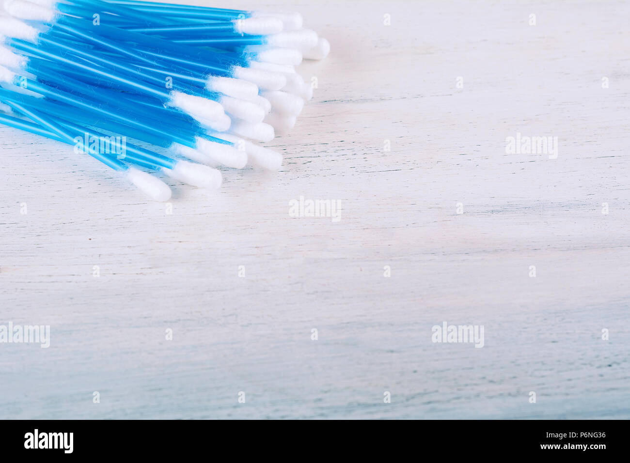 Stack of cotton buds on white wood background. Healthcare concept Stock ...