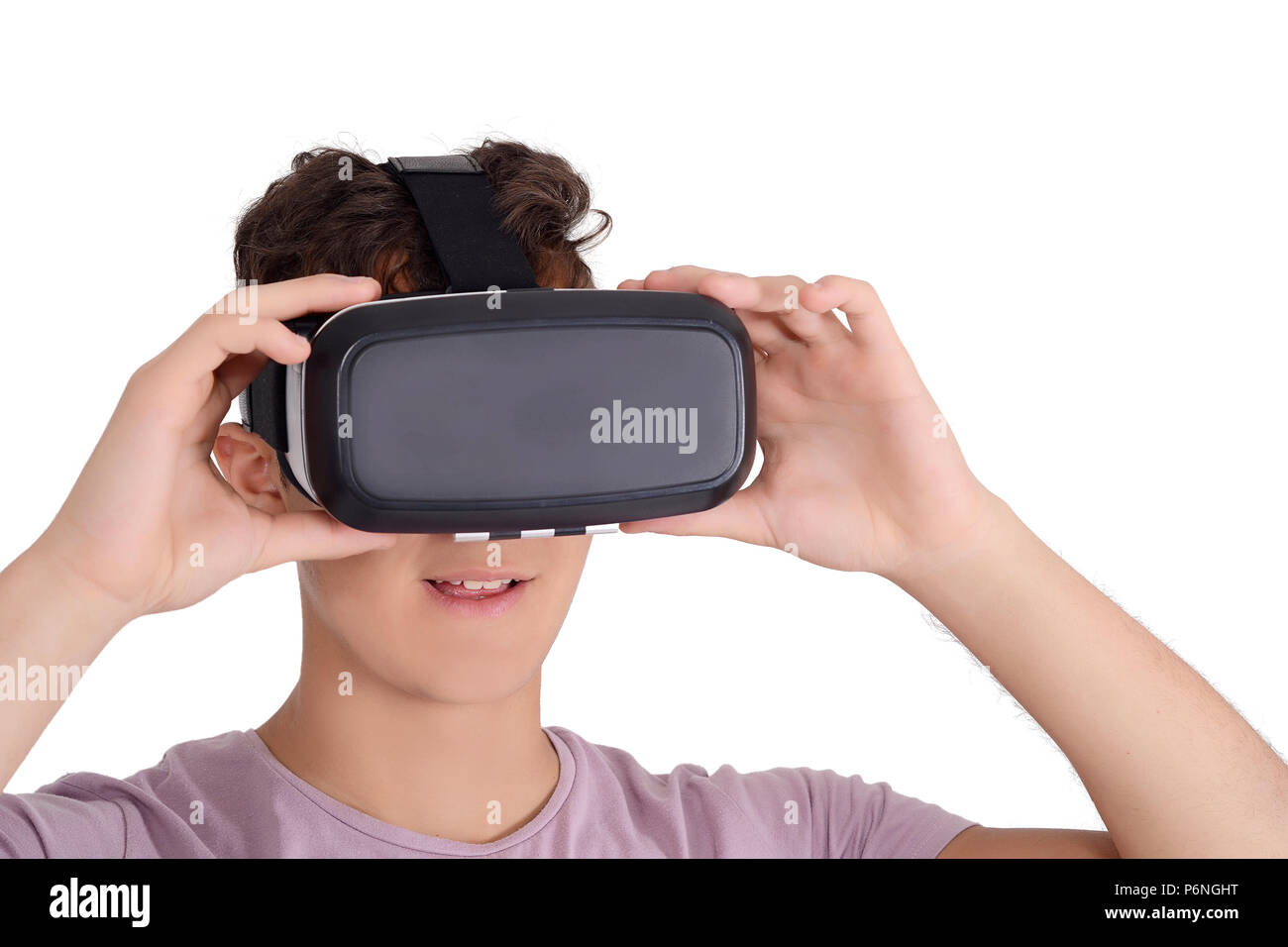 Joyful teen boy using VR goggles. Virtual reality concept. Isolated on ...