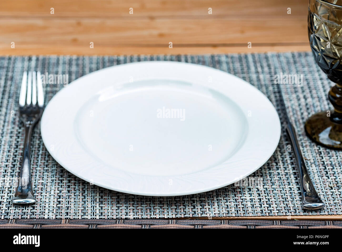 Table setting with fork, knife, plate and glass Stock Photo - Alamy